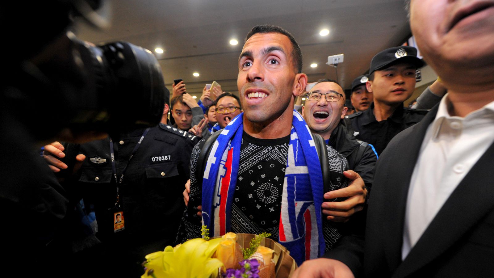 Carlos Tevez greeted at Chinese airport ahead of Shanghai Shenhua move ...