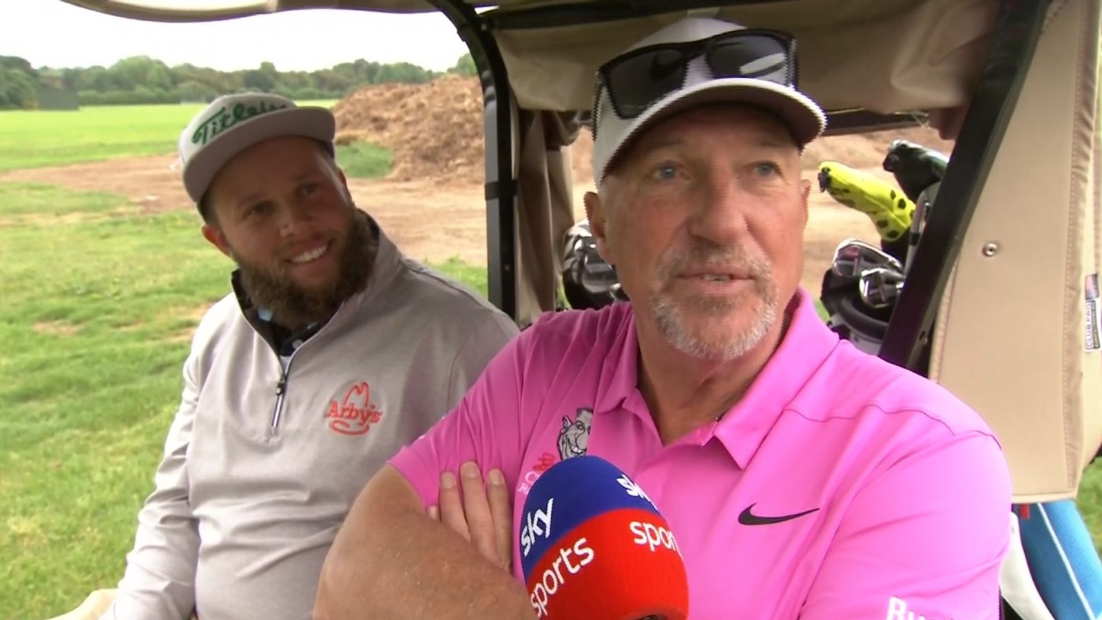 Watch as Sir Ian Botham's mis-hit gives Andrew Johnston fit of giggles ...
