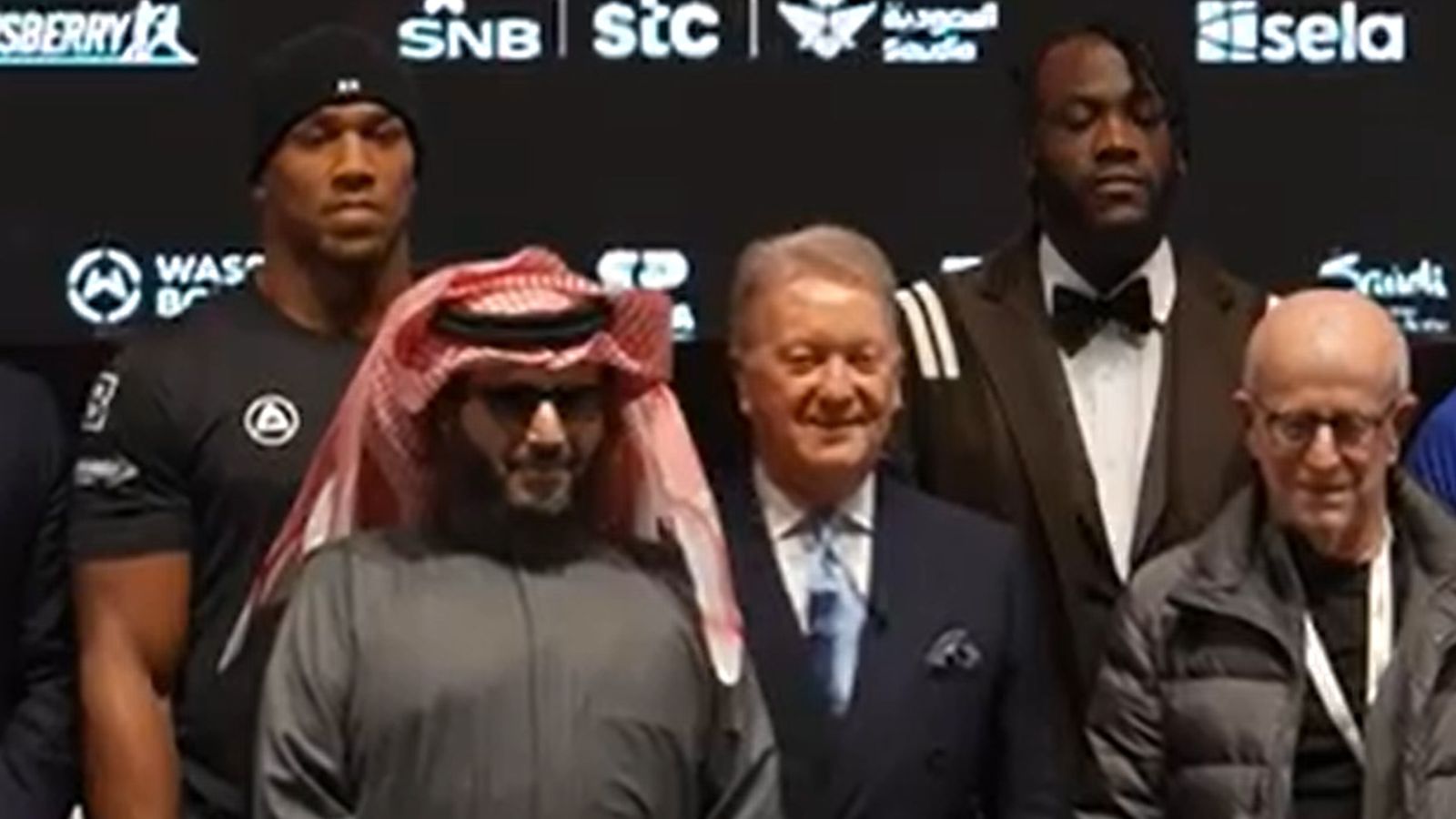 Awkward handshake! Anthony Joshua and Deontay Wilder briefly cease ...