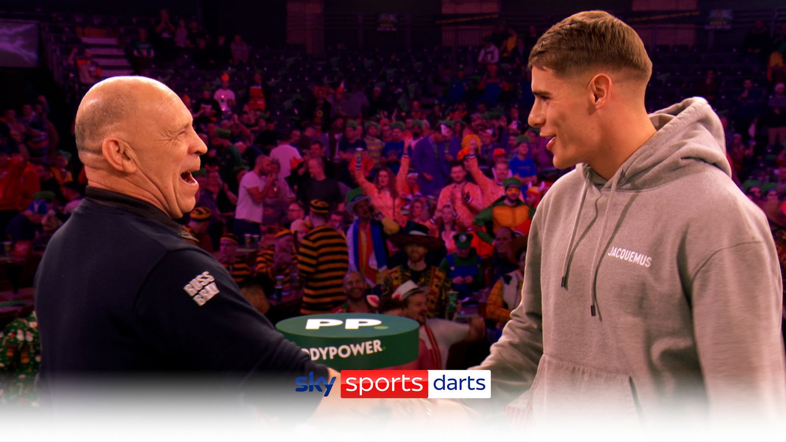 Spurs' Micky van de Ven takes on referee Russ Bray in nine-dart ...